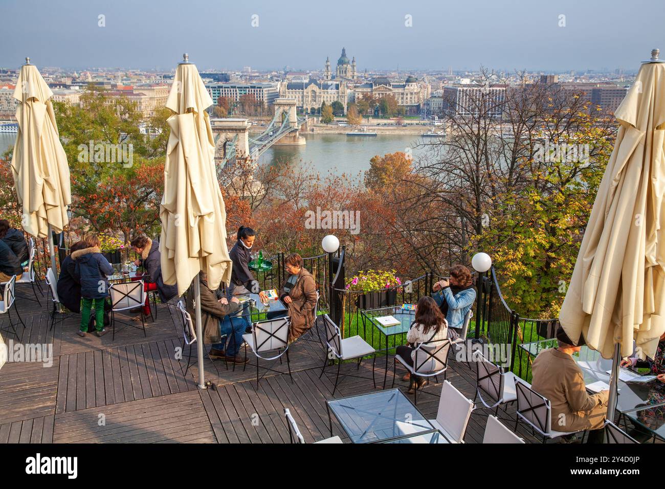Tourists Enjoy Drinks Outside On A Patio At Buda Castle Cafe Budapest ...