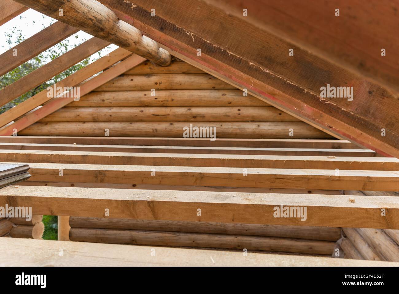 Log house roof is under construction. New wooden house is made of ...