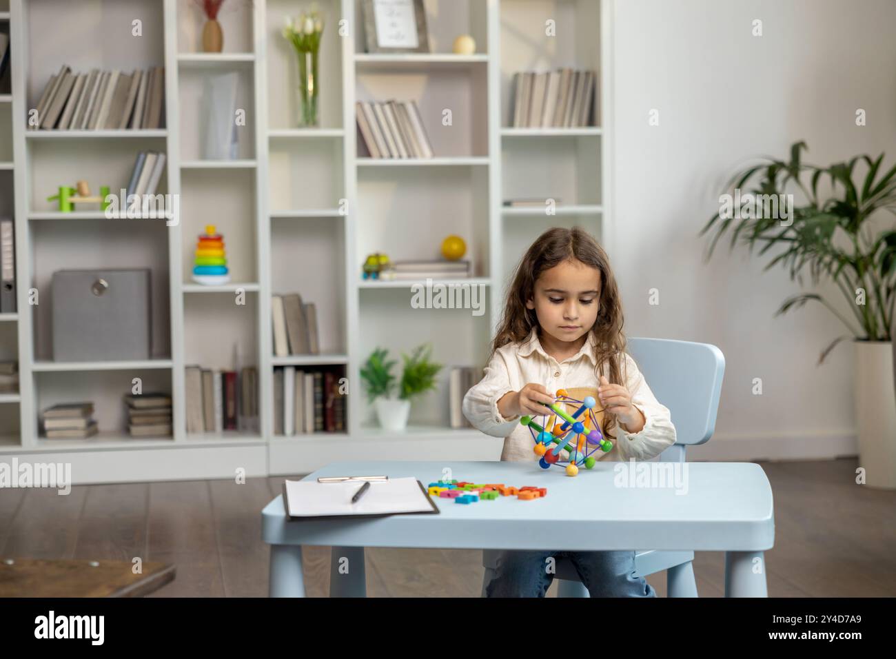 Cute long-haired girl looking busy while having a tutorial with a ...