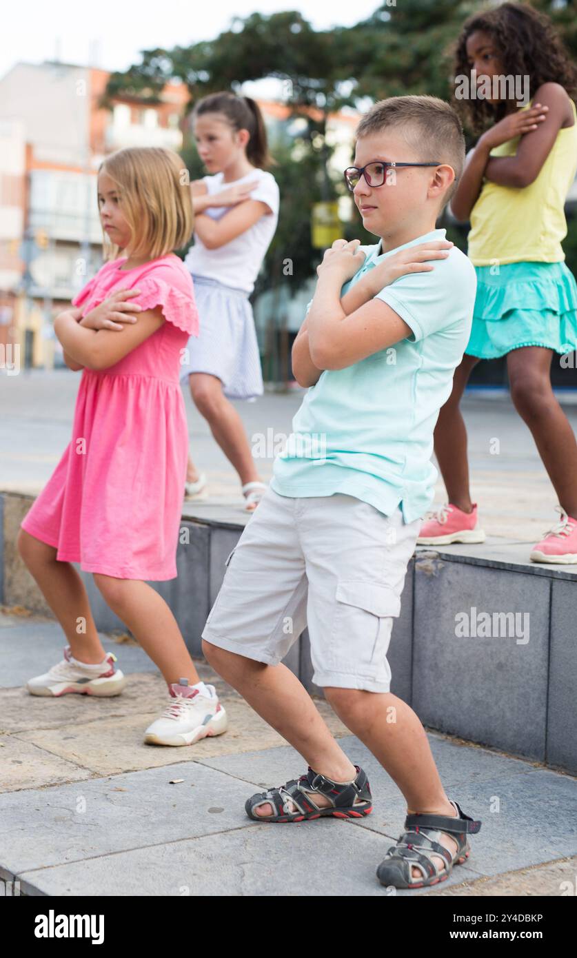 Group of kids performing street dance outdoors Stock Photo - Alamy