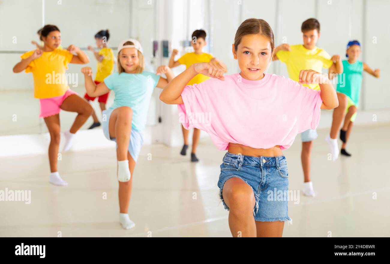 Tween girl breakdancer posing during group dance class Stock Photo - Alamy