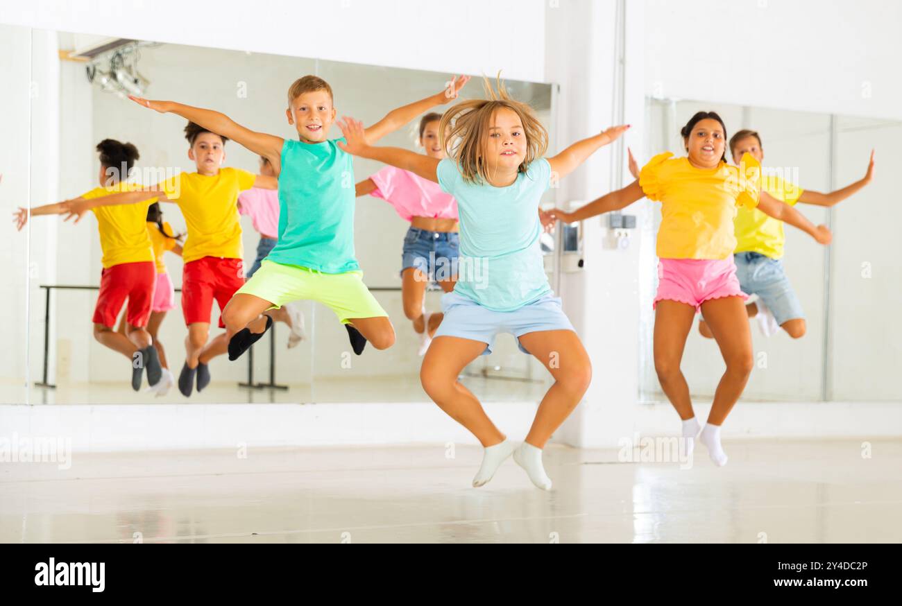 Kids jumping together in studio Stock Photo - Alamy