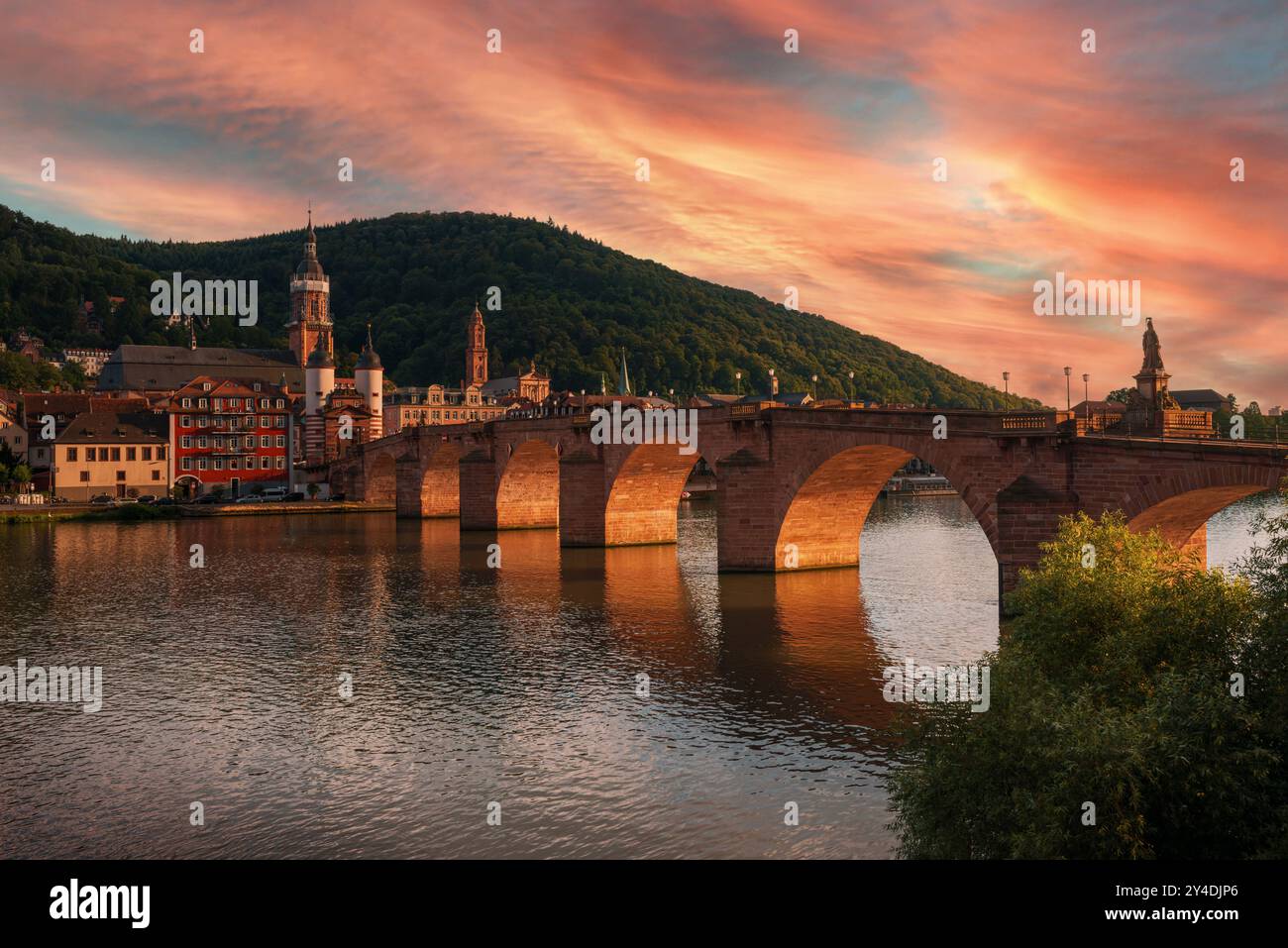 The Old Bridge in Heidelberg, Germany, with dramatic orange light at ...