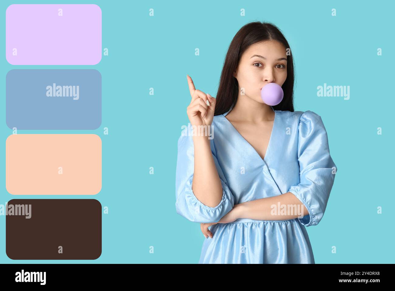 Beautiful young Asian woman with chewing gum on blue background ...