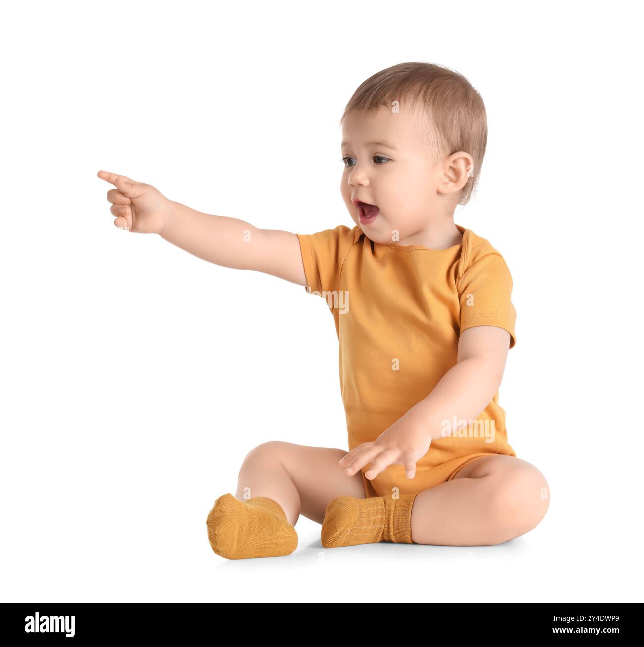 Cute baby pointing at something on white background Stock Photo - Alamy