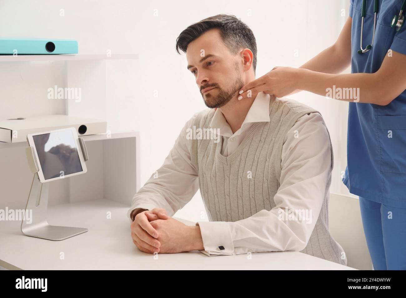 Female doctor checking man's pulse in clinic Stock Photo - Alamy