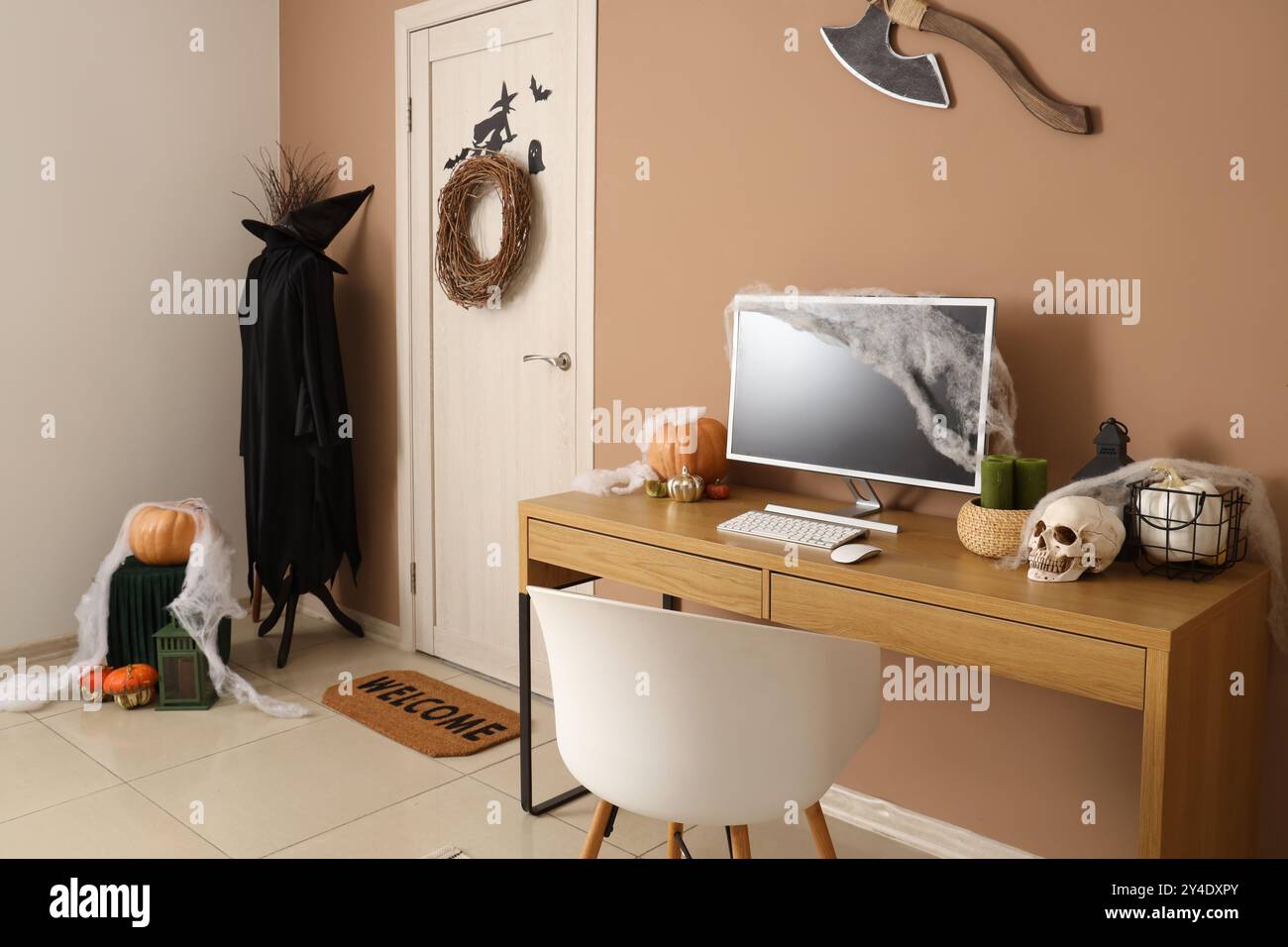 Interior of office decorated for Halloween with door, witch costume and ...