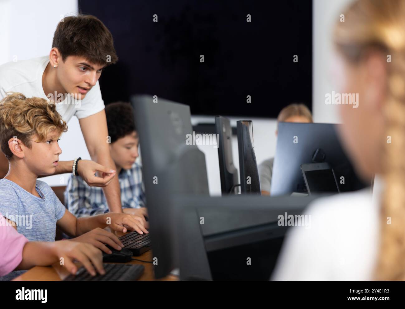 Girl student learning to work on computer in classroom Stock Photo - Alamy