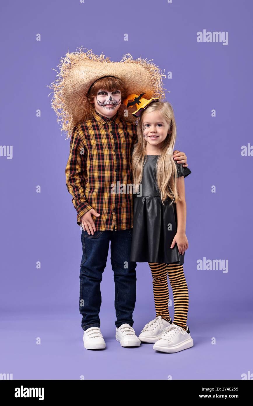 Cute children wearing costumes on violet background. Halloween ...