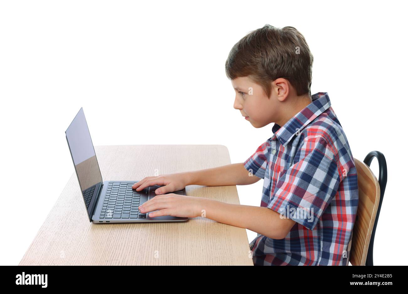 Boy with incorrect posture using laptop at wooden desk on white ...