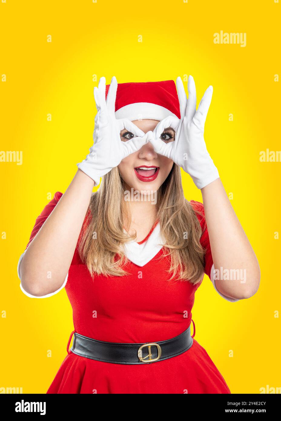 Young latina woman dressed as santa claus looks at camera putting her ...