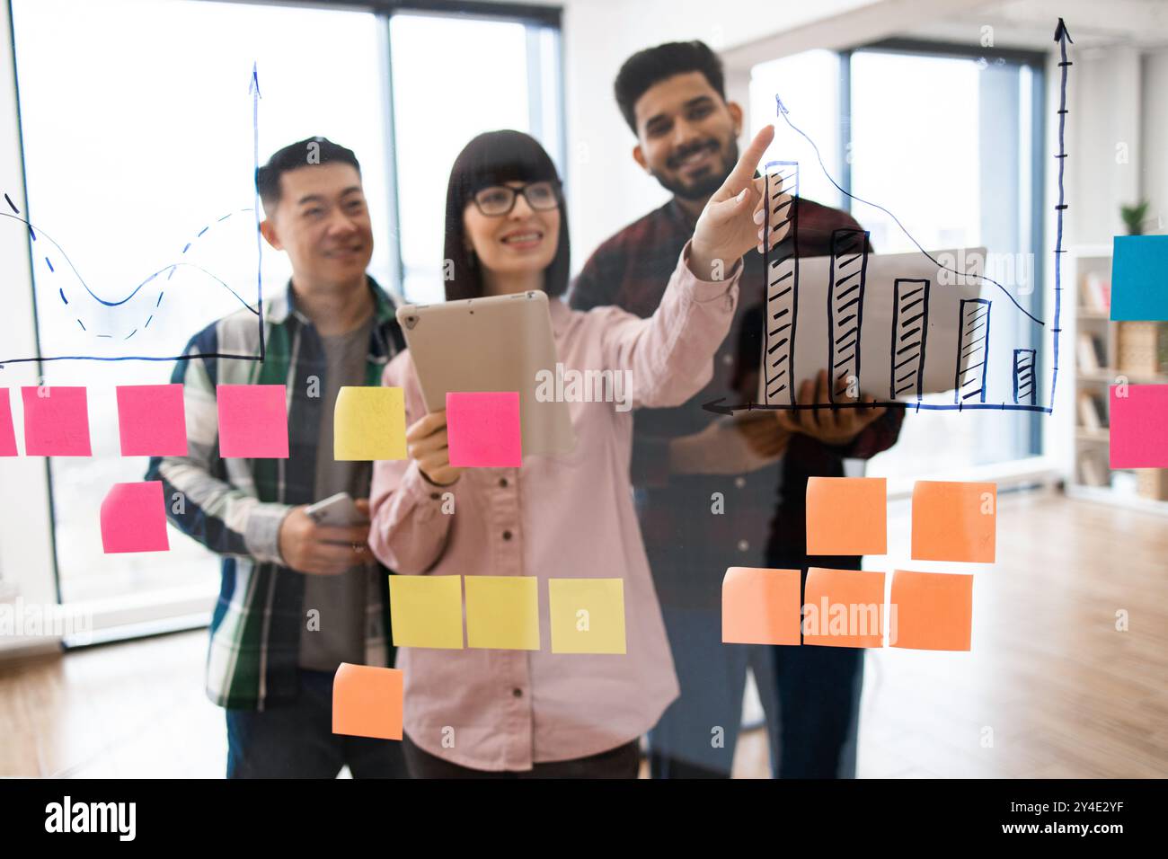 Creative team brainstorming with charts and sticky notes Stock Photo ...