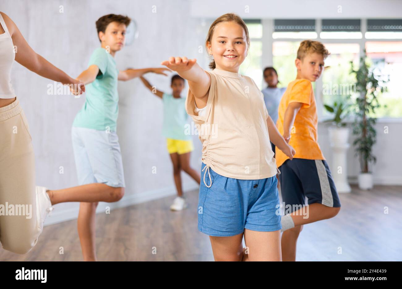 Smiling tween girl practicing vigorous dance in pair with boy Stock ...