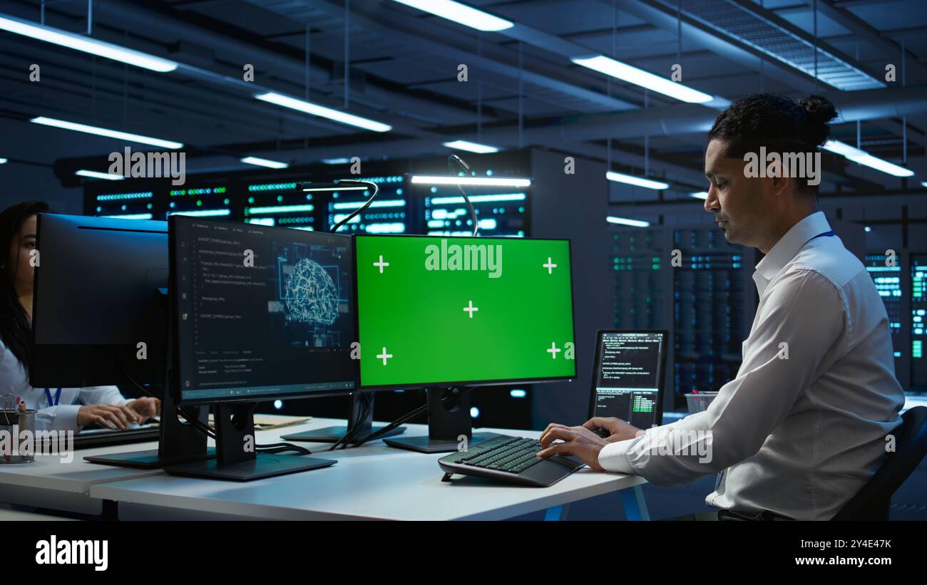 Engineer using AI tech on green screen PC to do checkup in server room. Zoom in of expert in ...