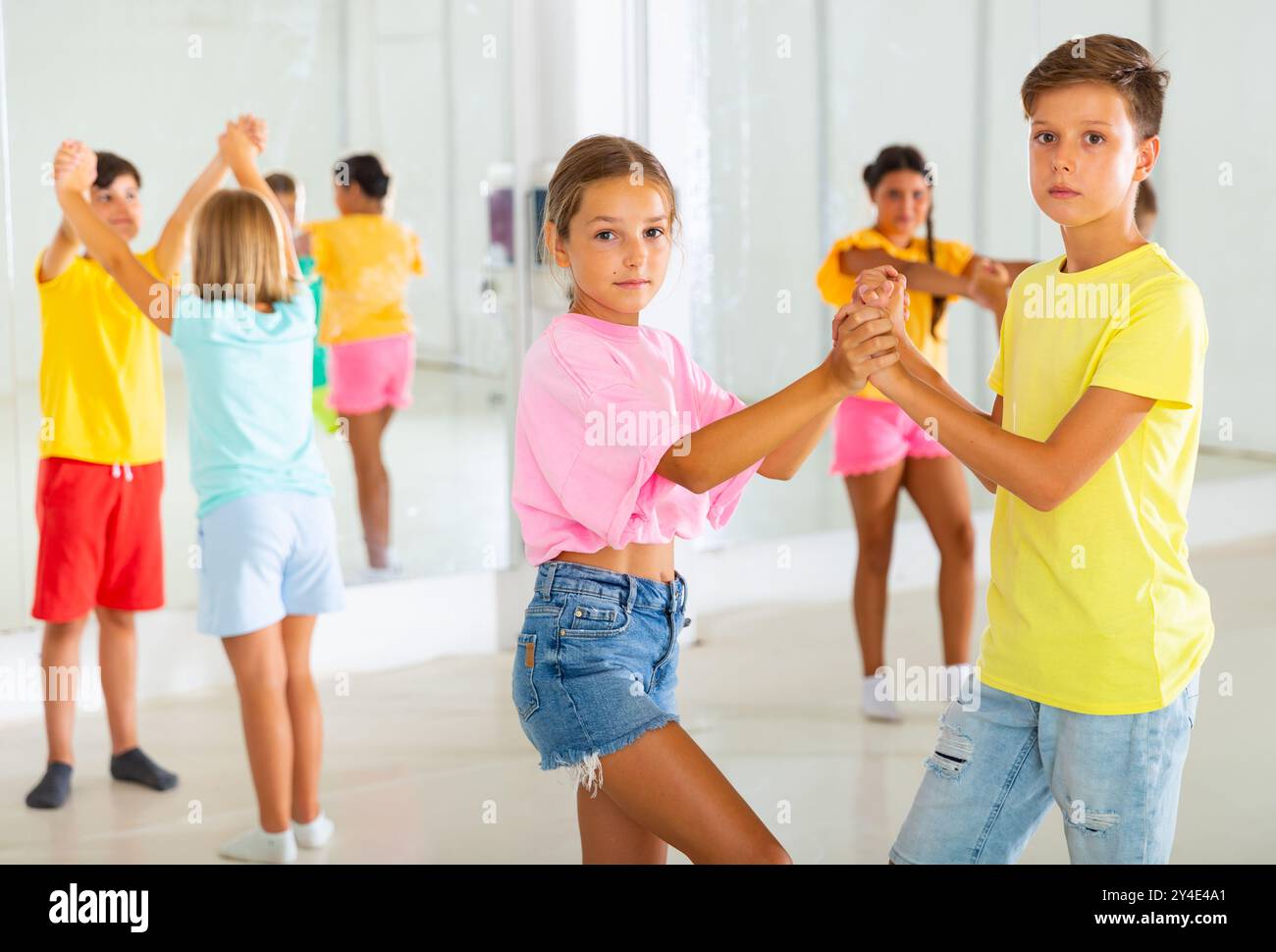 Group of kids dancing salsa in studio Stock Photo - Alamy