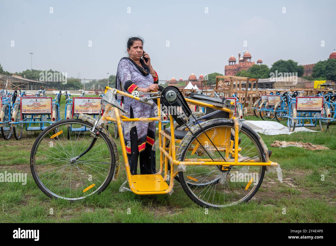 A woman seen with a new handicapped manual tricycle, which she received ...