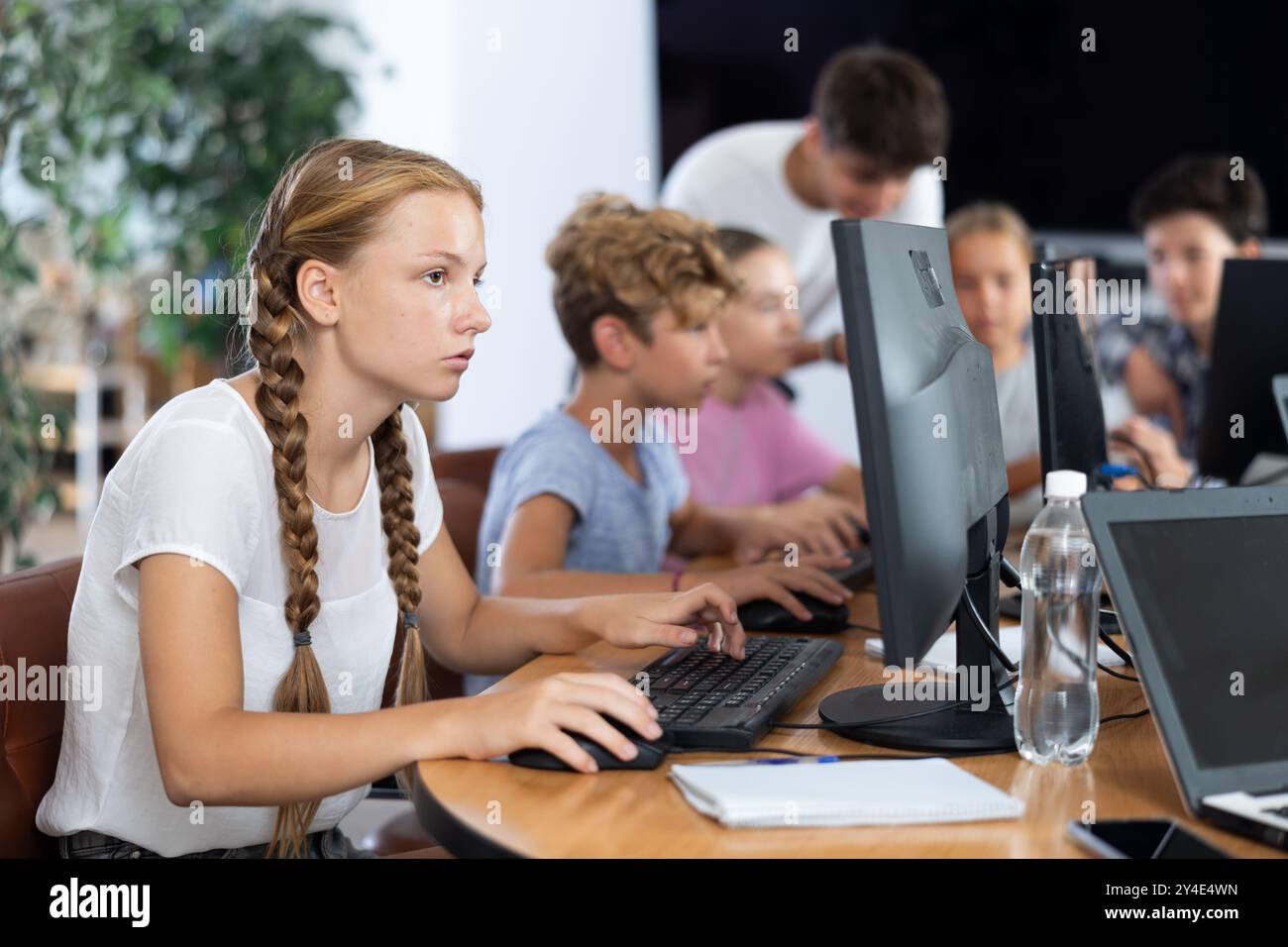 Girl student learning to work on computer in classroom Stock Photo - Alamy