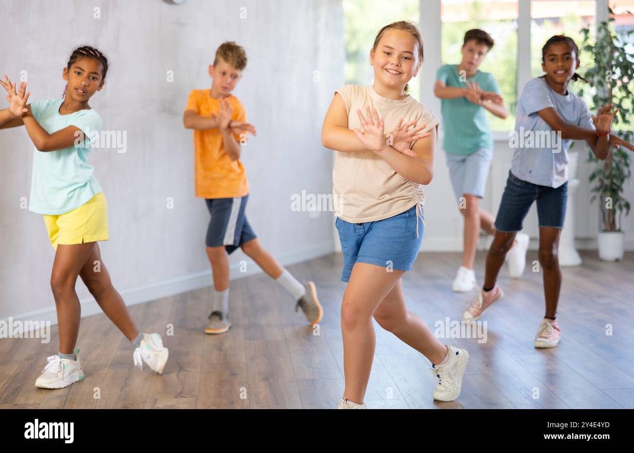 Energetic tween girl practicing vigorous movements in children dance ...