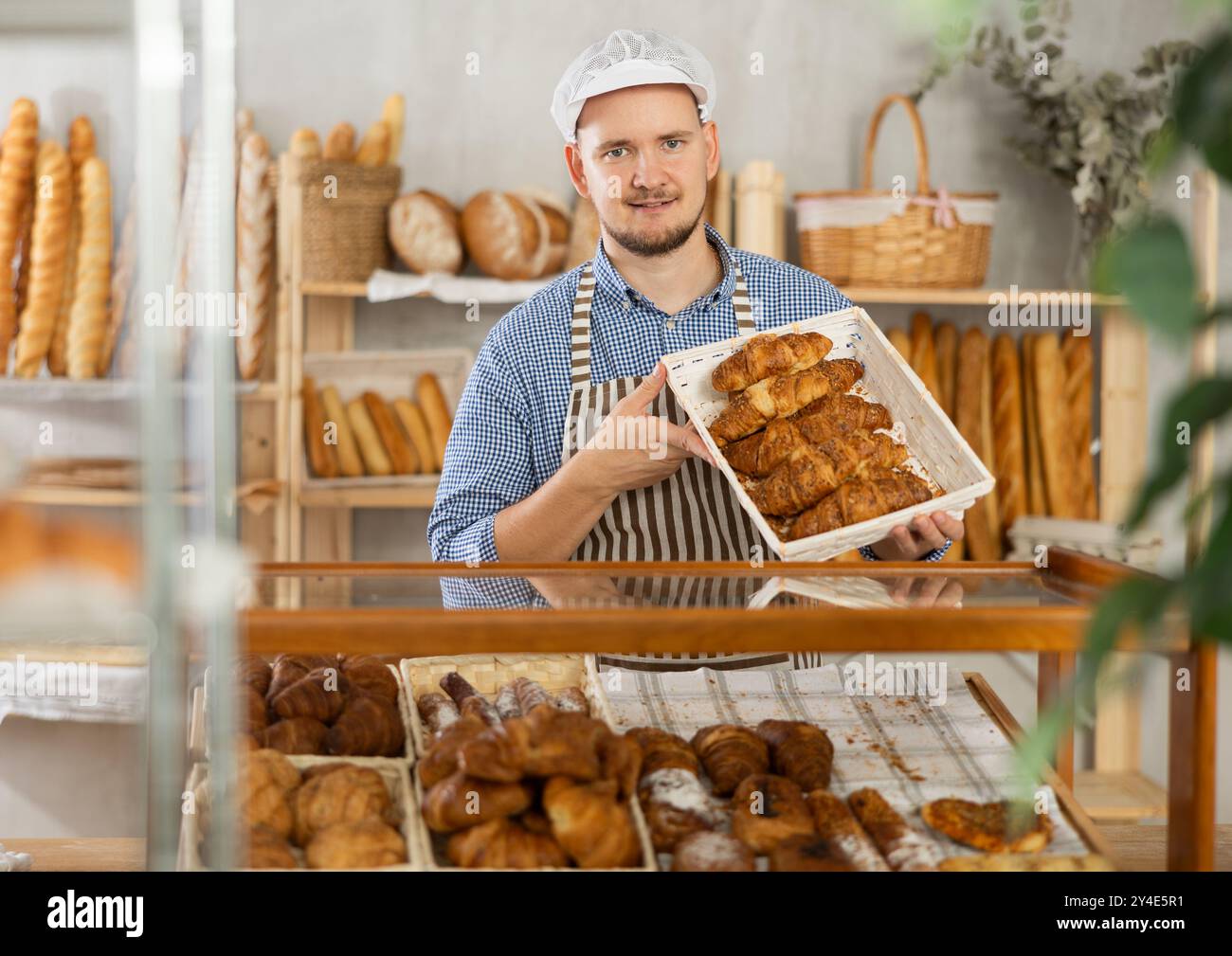 Baker places bread dough in hi-res stock photography and images - Alamy