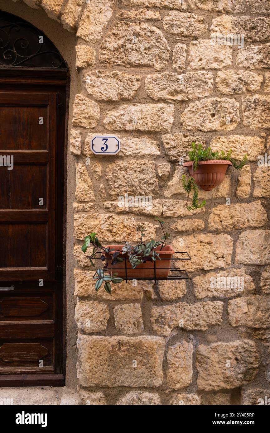 Rustic Stone Wall with Potted Plants Stock Photo - Alamy