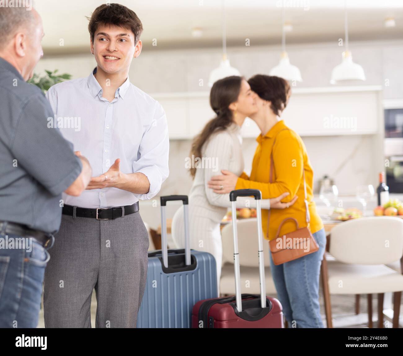 Son-in-law greeting visiting elderly father-in-law with handshake Stock ...