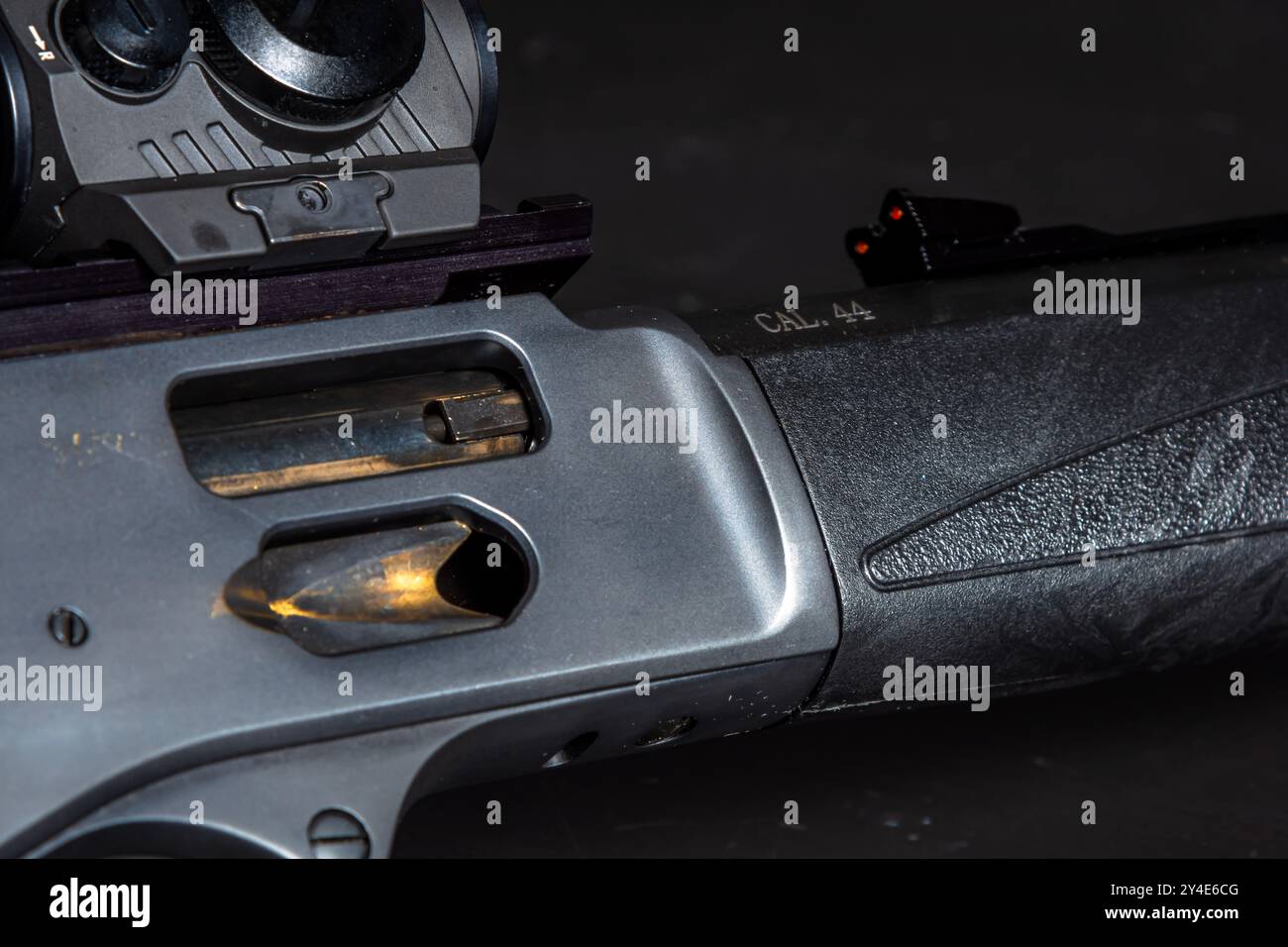 SIde gate on a lever action rifle with the bolt closed and a red dot ...