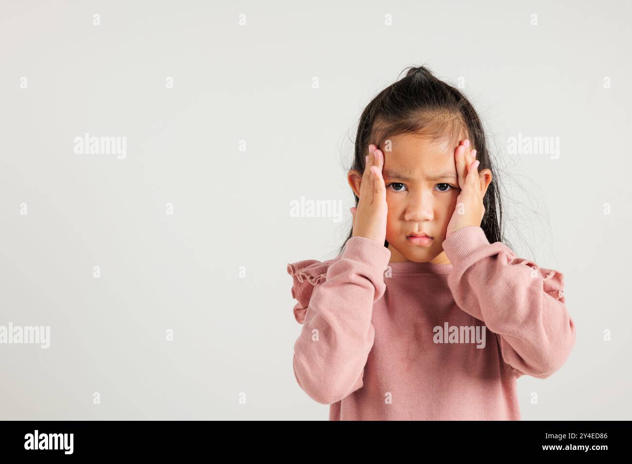 Portrait of Asian young kid girl sad tired strain face holding hold ...