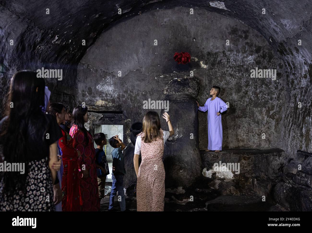 Lalisch, Iraq. 12th Sep, 2024. A Yazidi woman throws a red cloth on a ...