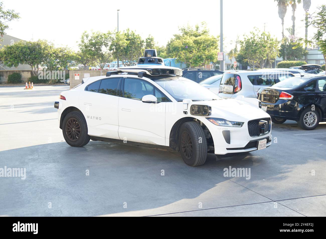 A self driving Waymo car executes three point turn in a crowded parking ...