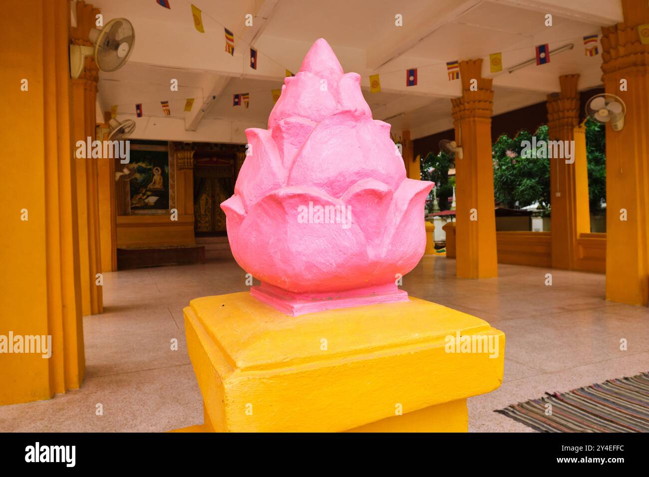 Painted concrete pink lotus flower column at Buddhist temple complex ...
