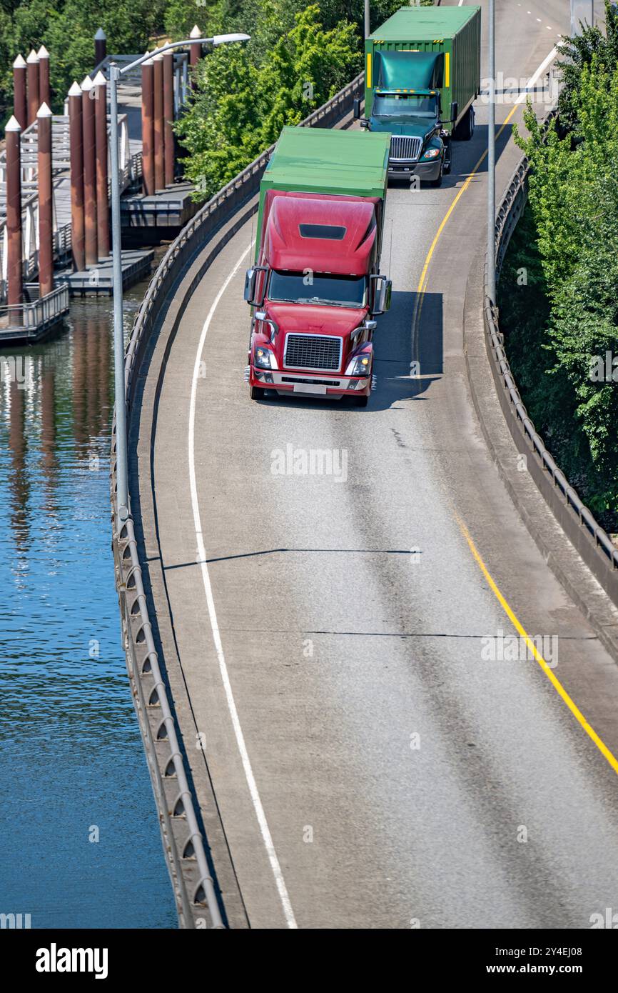 Commercial long hauler Team of two big rig semi trucks transporting ...