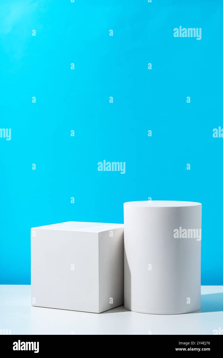 Two geometric shapes on display against a bright blue background in a ...