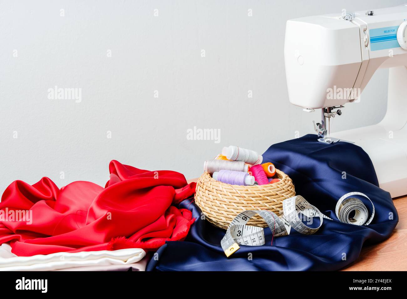 Sewing tools and materials arranged on fabric with a sewing machine in ...