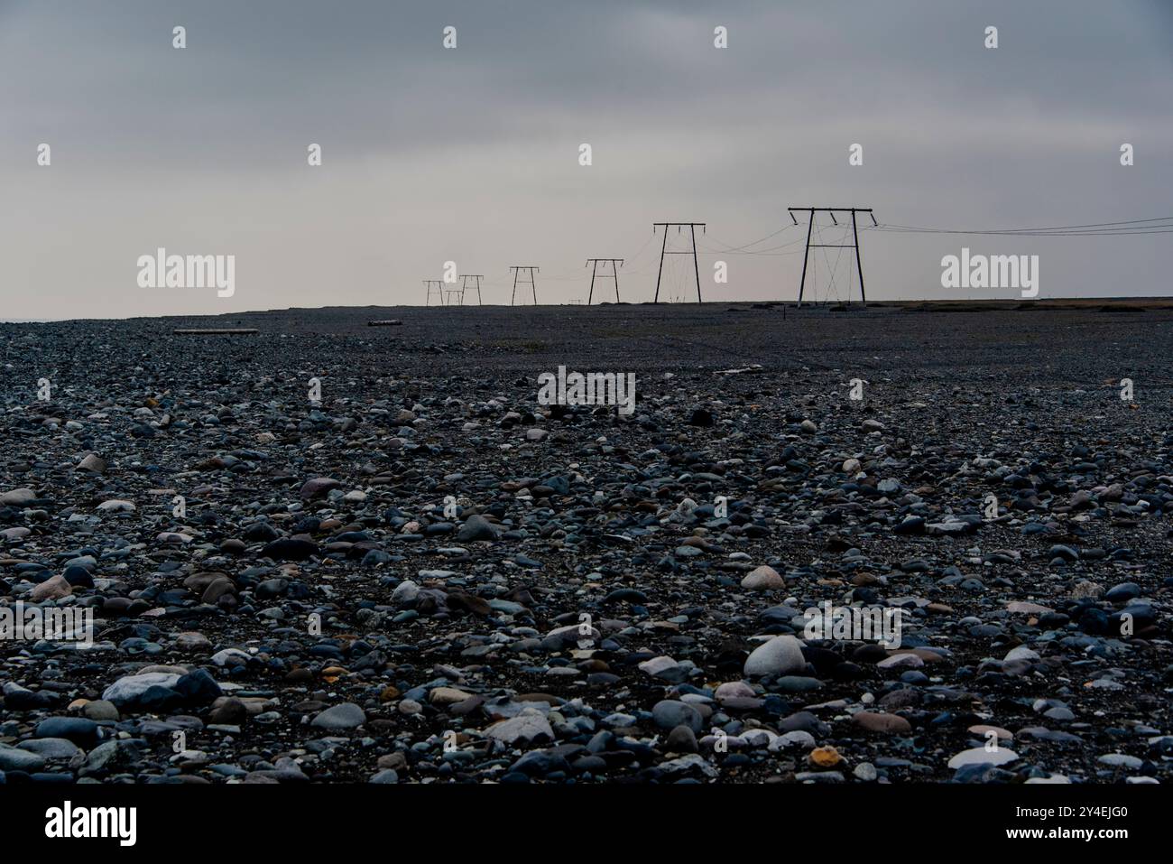 power lines with symmetrical wooden pylons stand out over desolate ...