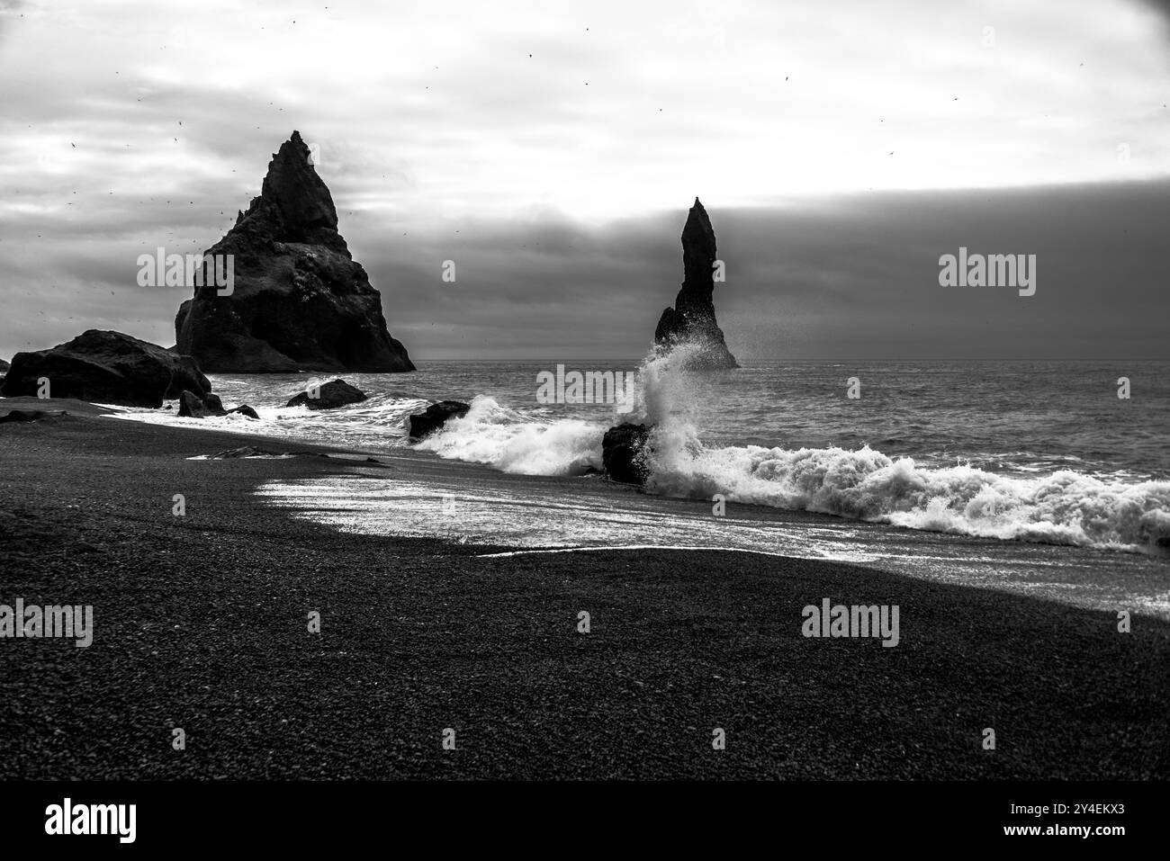 black lava pebble beach with waves crashing clamorously on the black ...