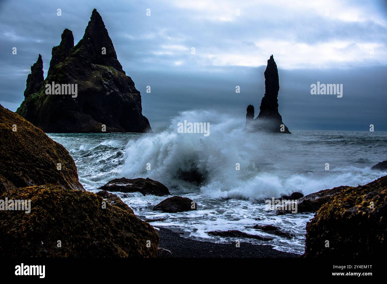 black lava pebble beach with waves crashing clamorously on the black ...