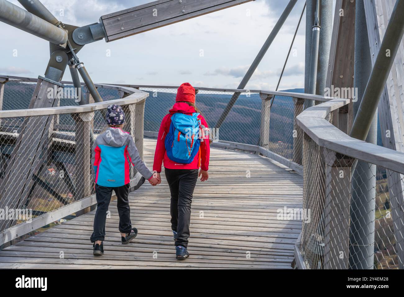 Visitors walk hand in hand along the wooden pathway of the Sky Walk ...