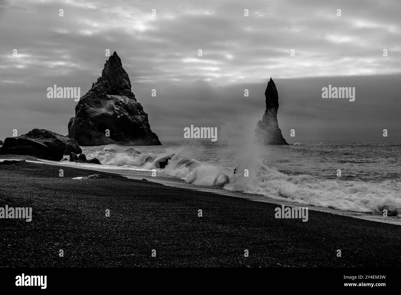 black lava pebble beach with waves crashing clamorously on the black ...