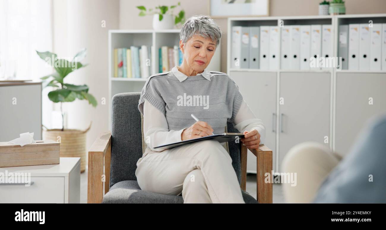 Therapist, client and writing in office, conversation and sad with ...