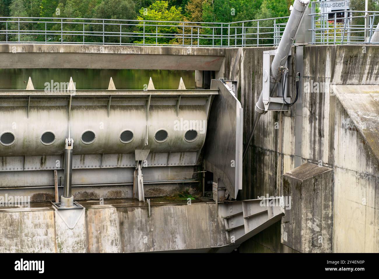 View of a closed spillway on a small dam on a river Stock Photo - Alamy