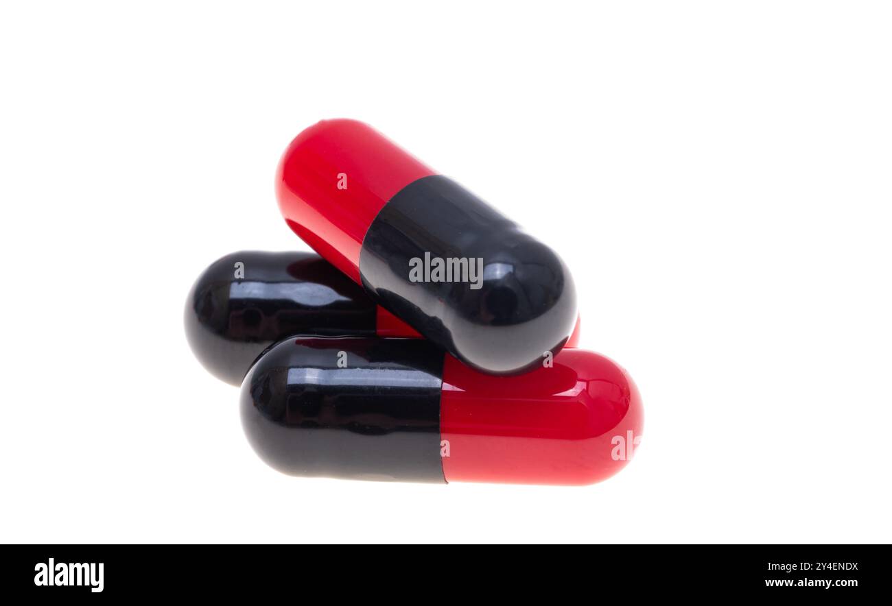 red black capsules isolated on white background Stock Photo - Alamy
