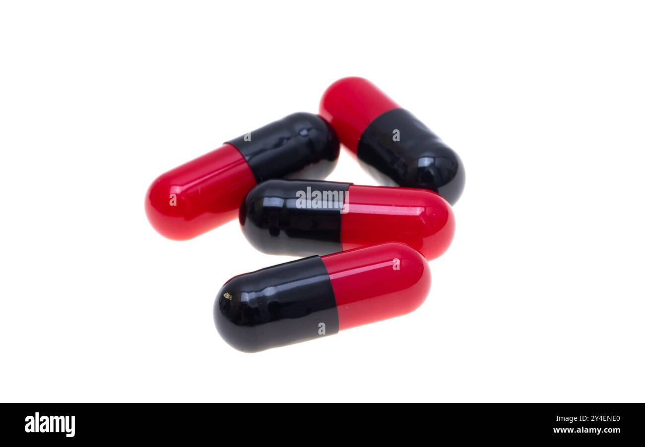 red black capsules isolated on white background Stock Photo - Alamy