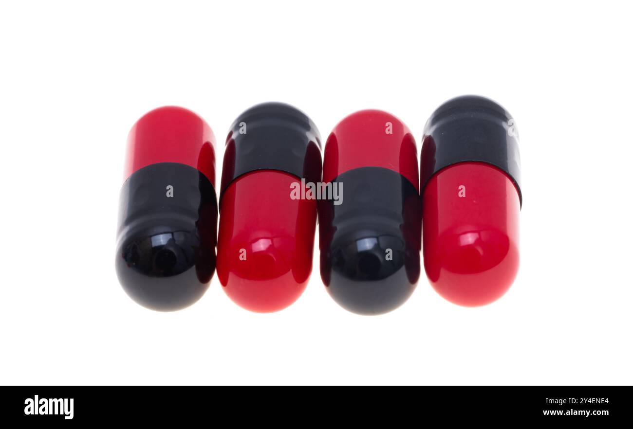 red black capsules isolated on white background Stock Photo - Alamy
