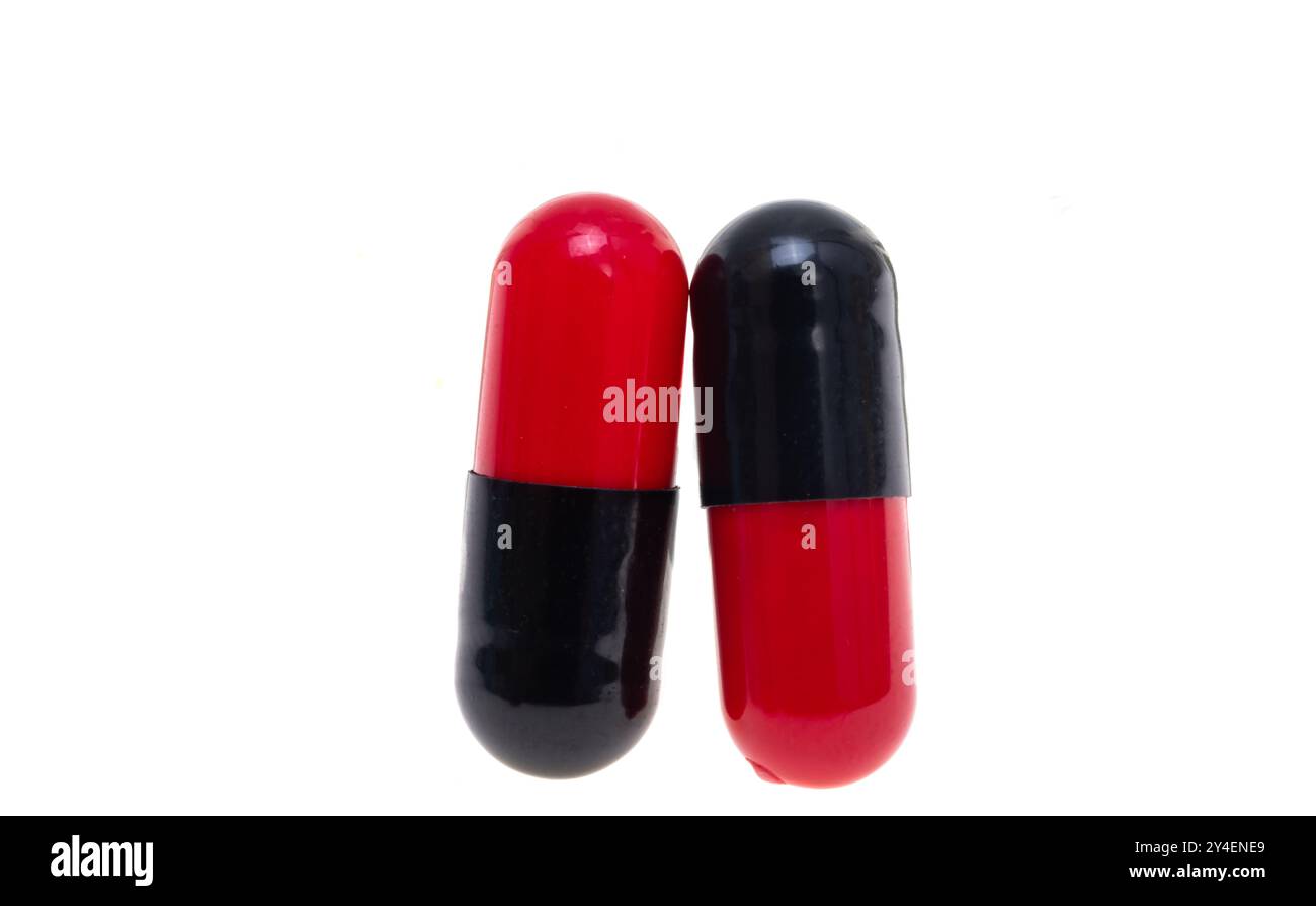 red black capsules isolated on white background Stock Photo - Alamy