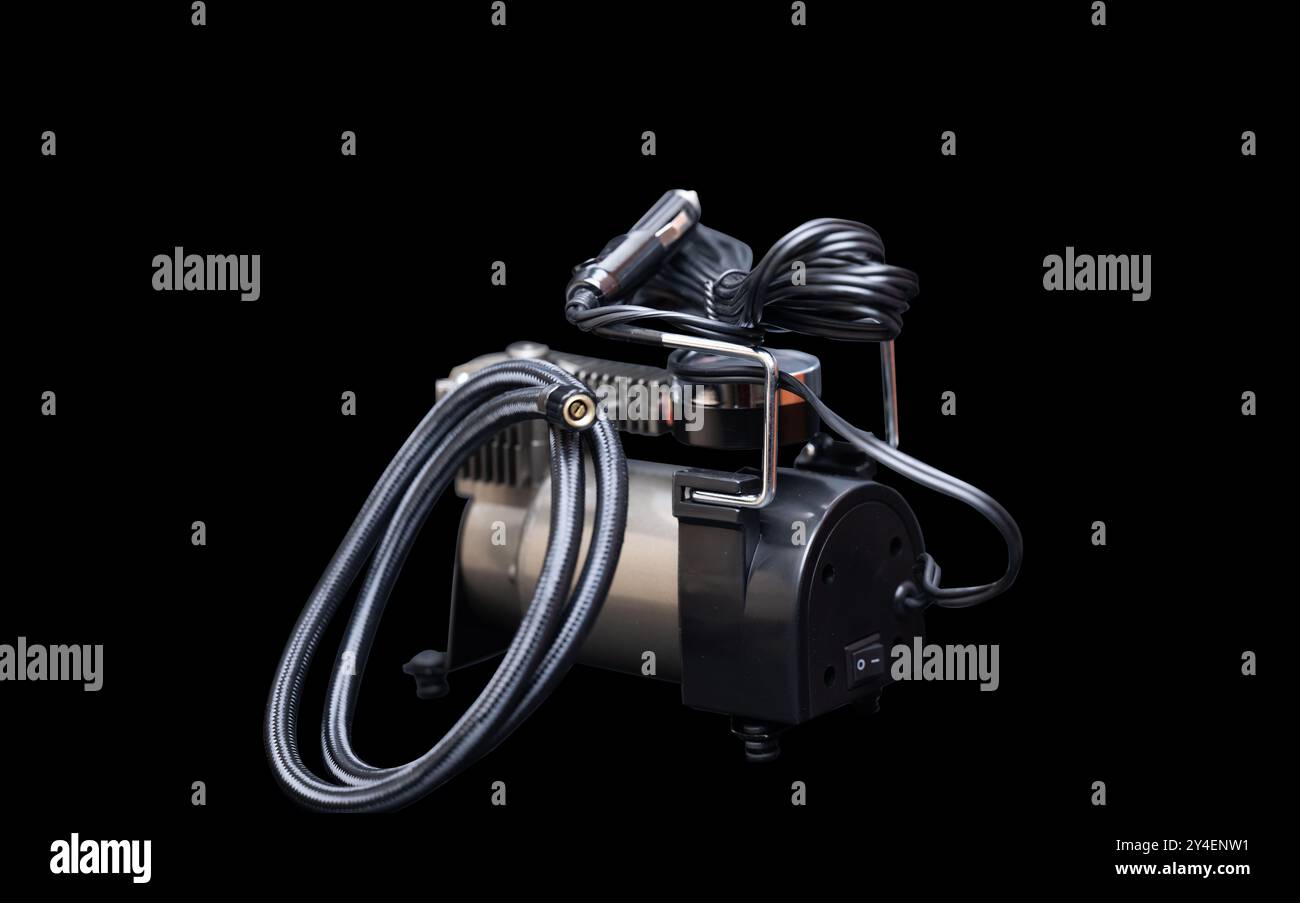 car tire compressor on black background Stock Photo - Alamy