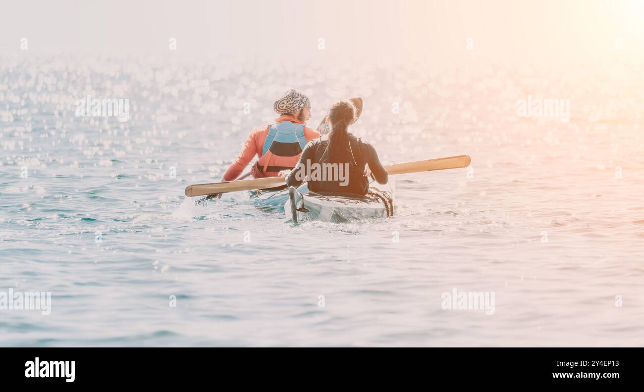Kayaking Ocean Water Sport: Two people kayak on a calm ocean, back view ...