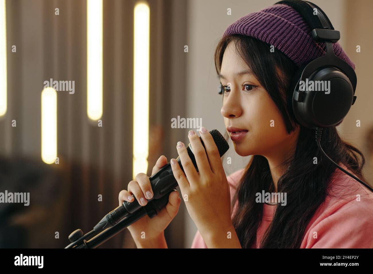 Girl Wearing Headphones Singing into Microphone Stock Photo - Alamy