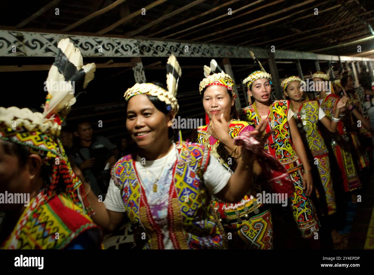 Women dancing in a line as they are welcoming guests during an ...