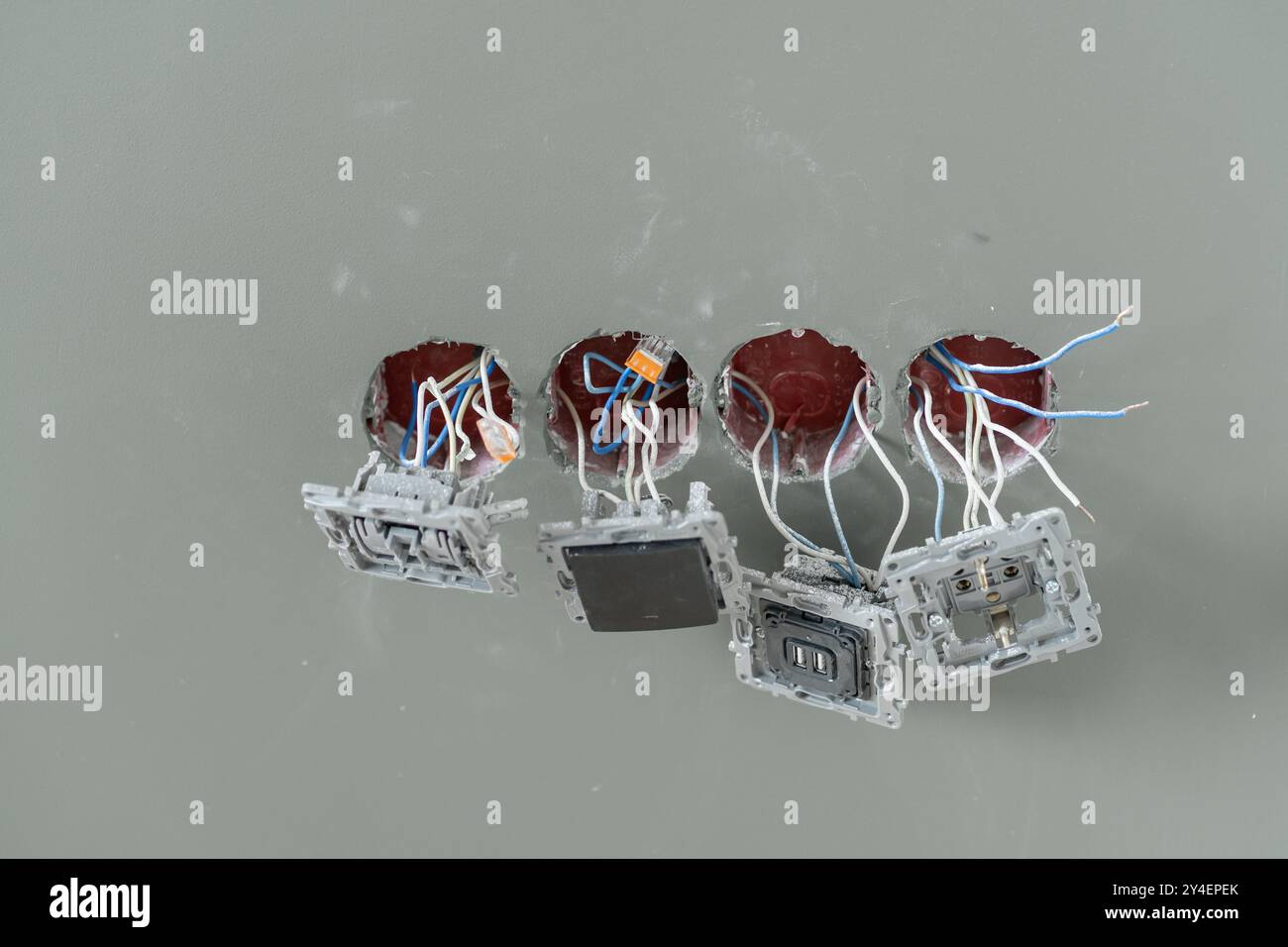 Exposed wiring and switch boxes are visible during a residential ...