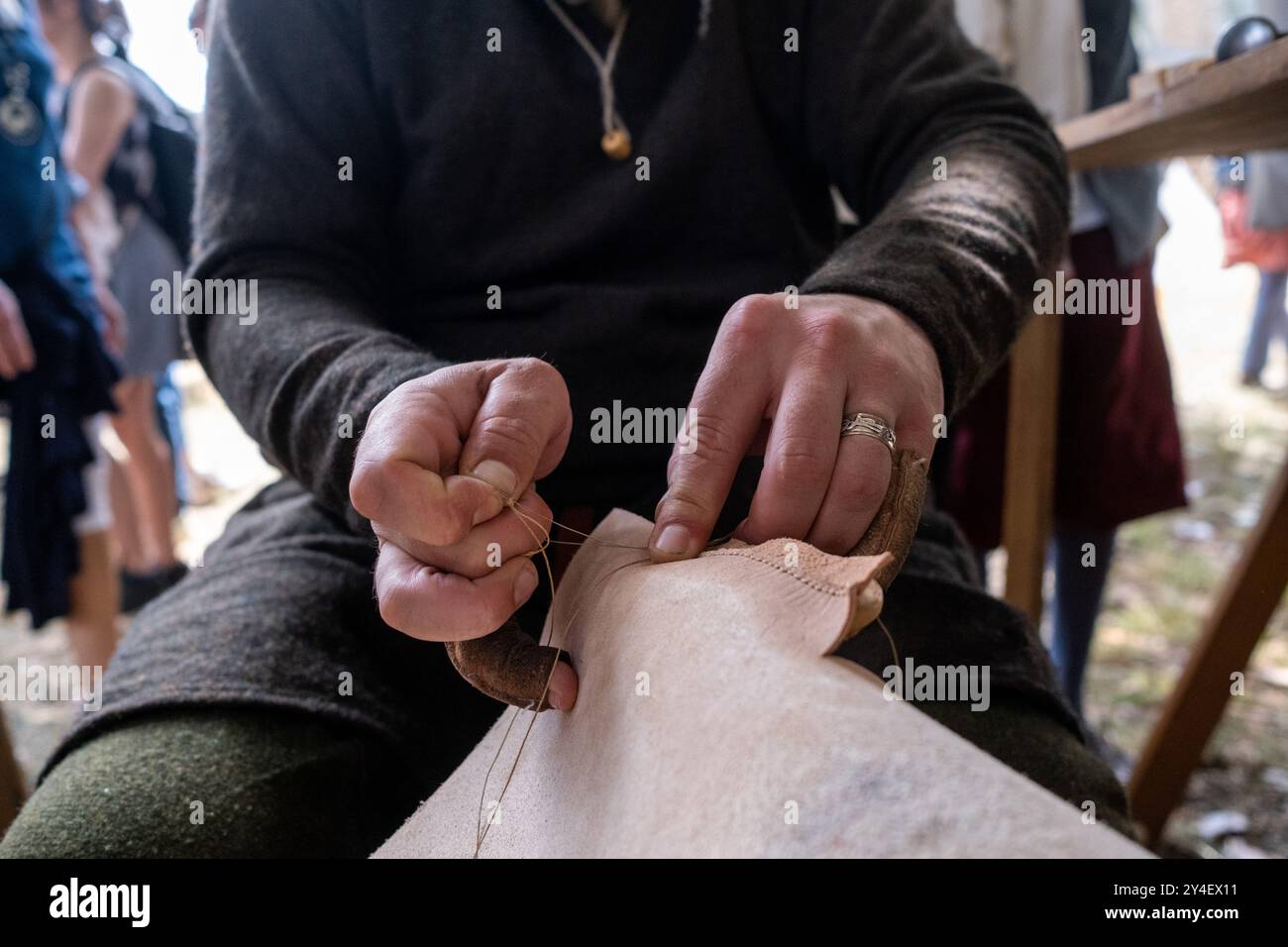 A traditional shoemaker making leather shoes in the style of the Middle ...